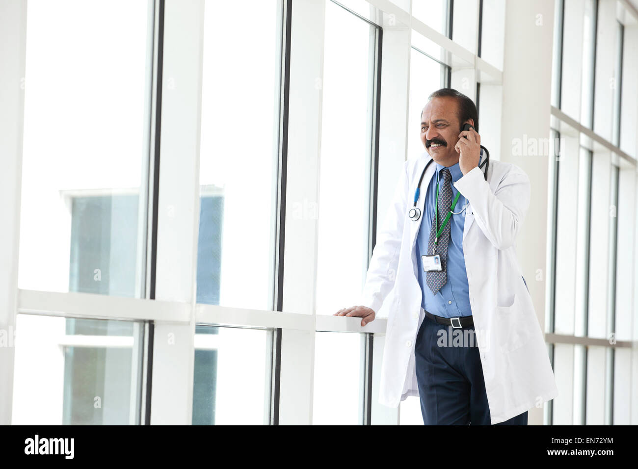 Doctor talking on a mobile phone Stock Photo - Alamy