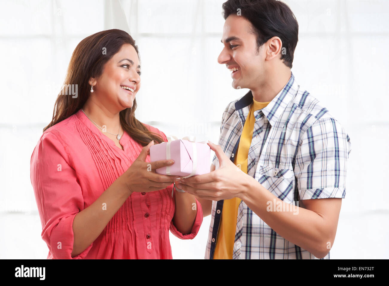 Son giving his mother a gift Stock Photo - Alamy