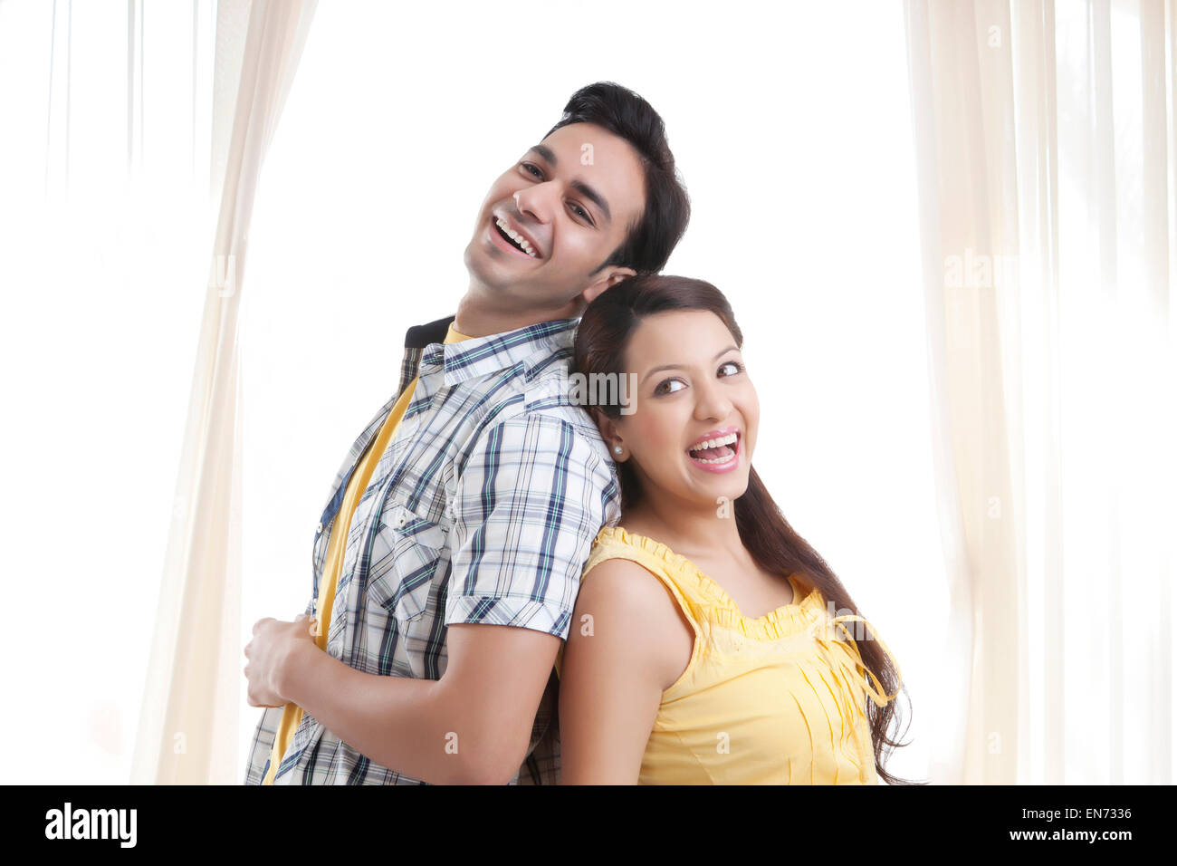 Indian couple standing back to back hi-res stock photography and images ...