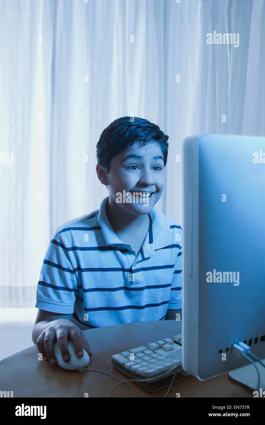 Young boy looking at a computer monitor Stock Photo - Alamy