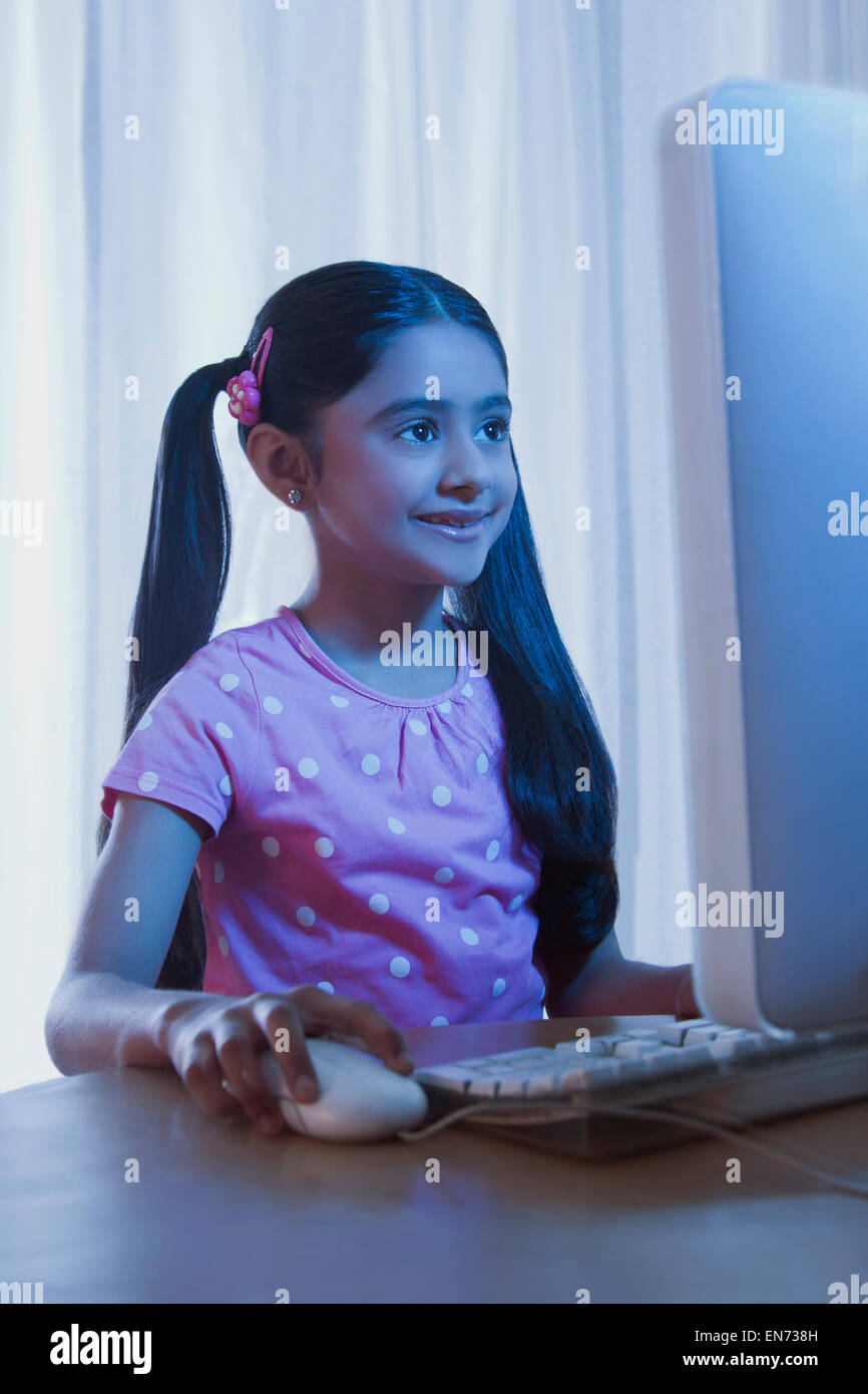Young girl using a computer Stock Photo - Alamy