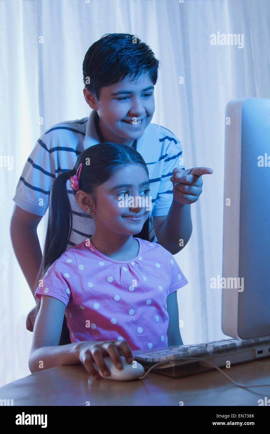 Boy pointing at computer screen Stock Photo - Alamy