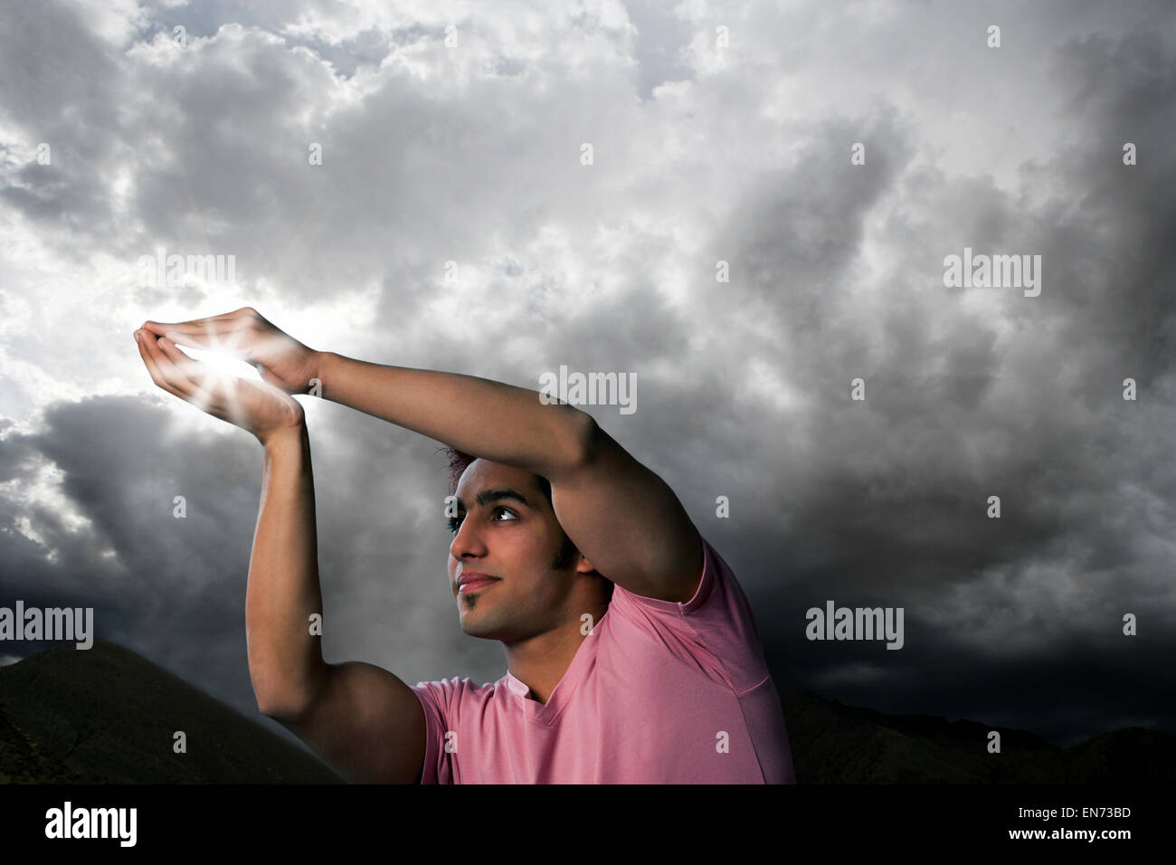 Man trying to catch sun rays Stock Photo - Alamy