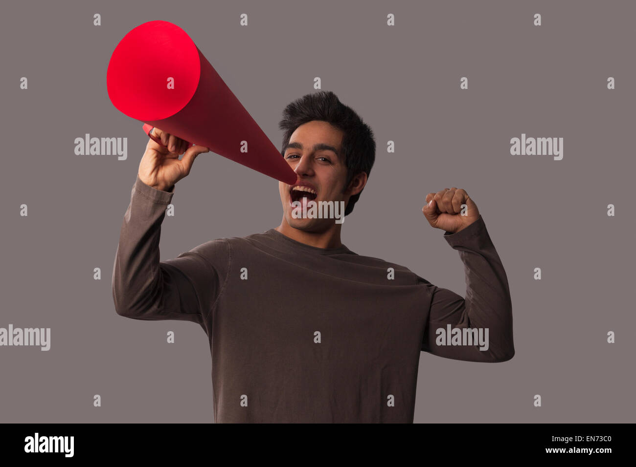 Young man holding megaphone hi-res stock photography and images - Alamy