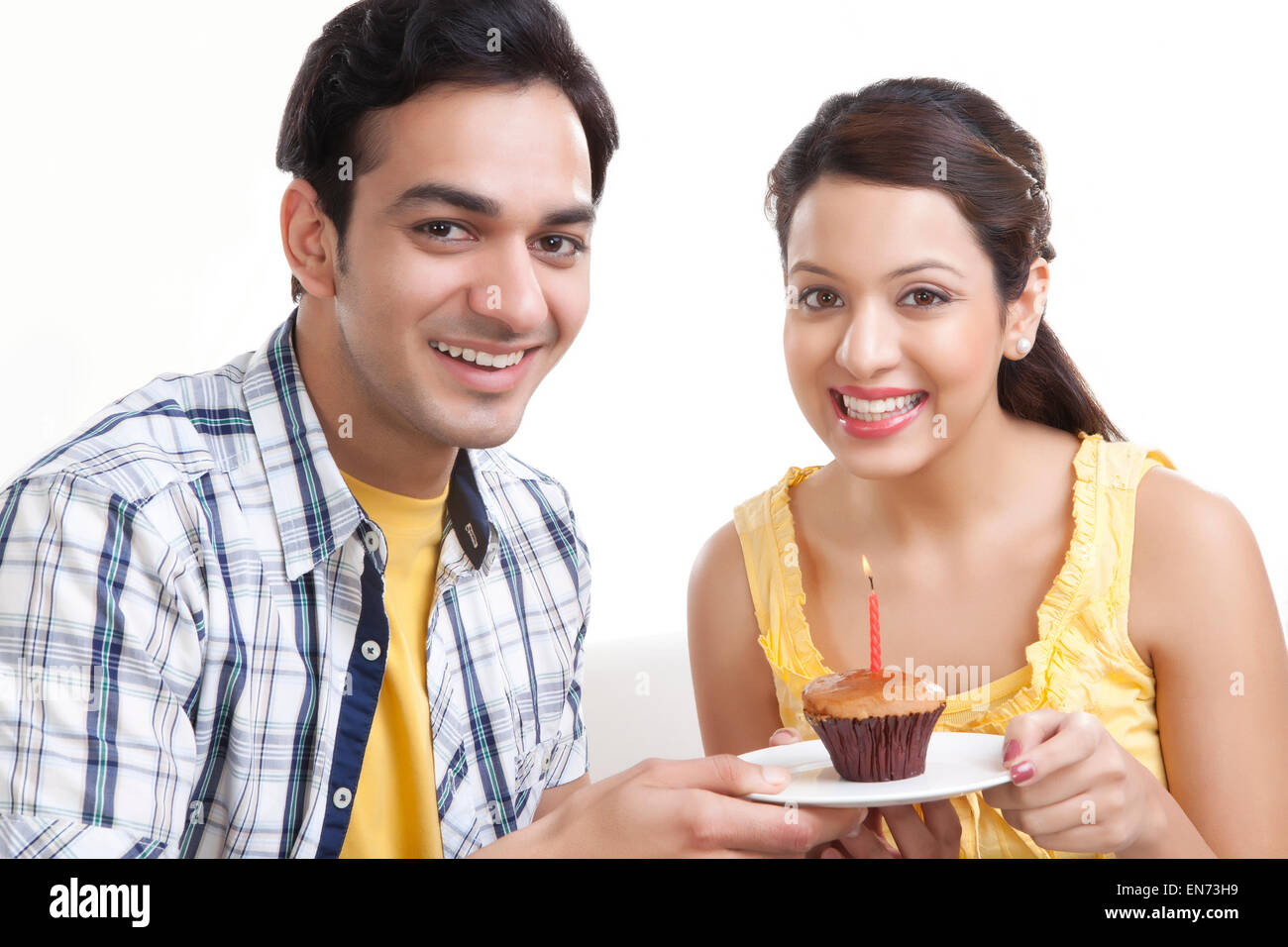 Portrait of young couple with a cupcake Stock Photo - Alamy