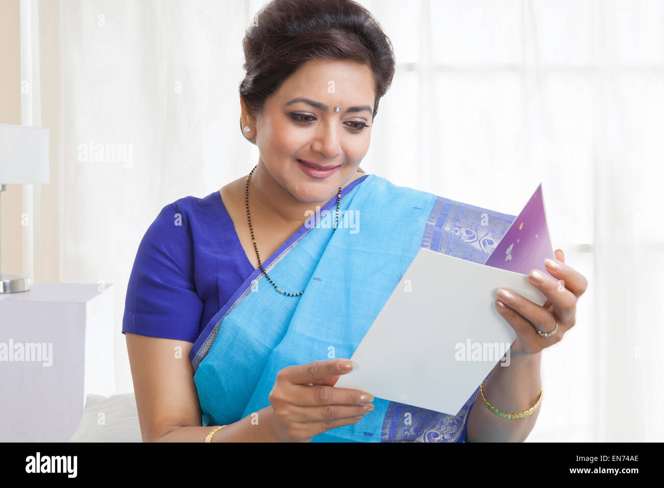 Senior woman reading a greeting card Stock Photo - Alamy