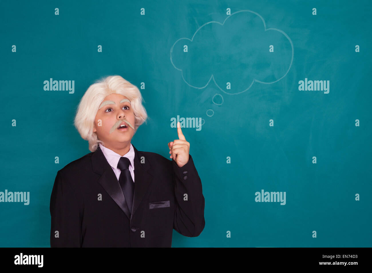 Boy dressed as Einstein thinking Stock Photo - Alamy