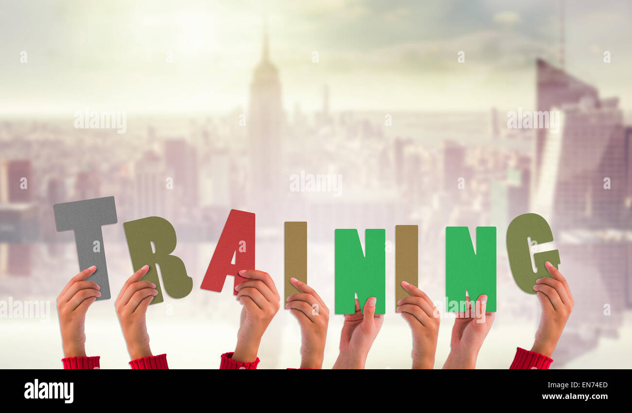 Composite image of hands holding up training Stock Photo - Alamy
