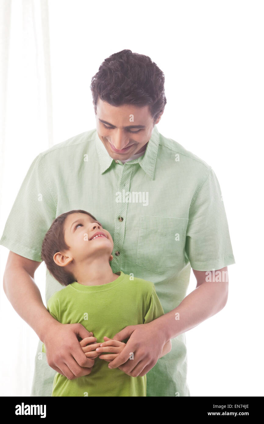 Father looking down at his son Stock Photo - Alamy
