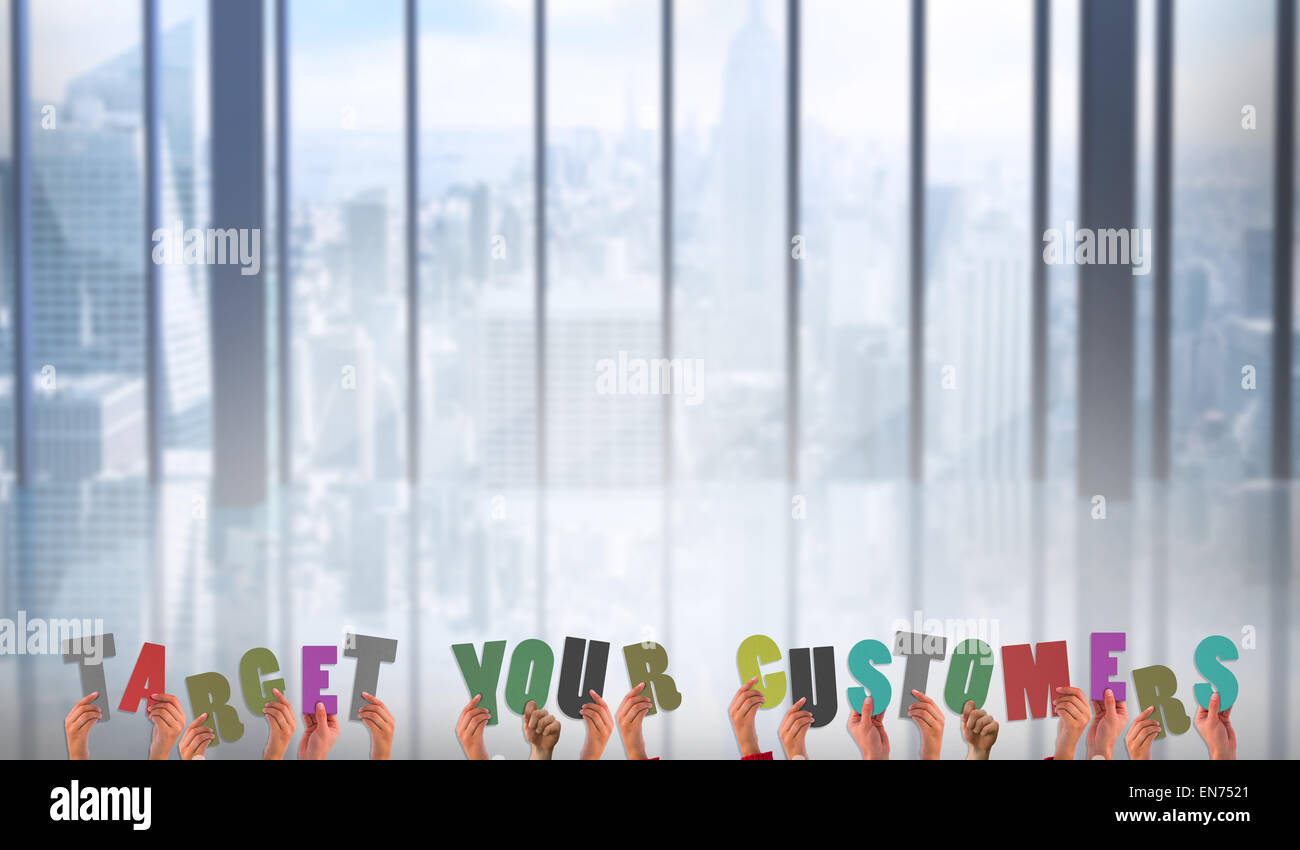 Composite image of hands holding up target your customers Stock Photo ...