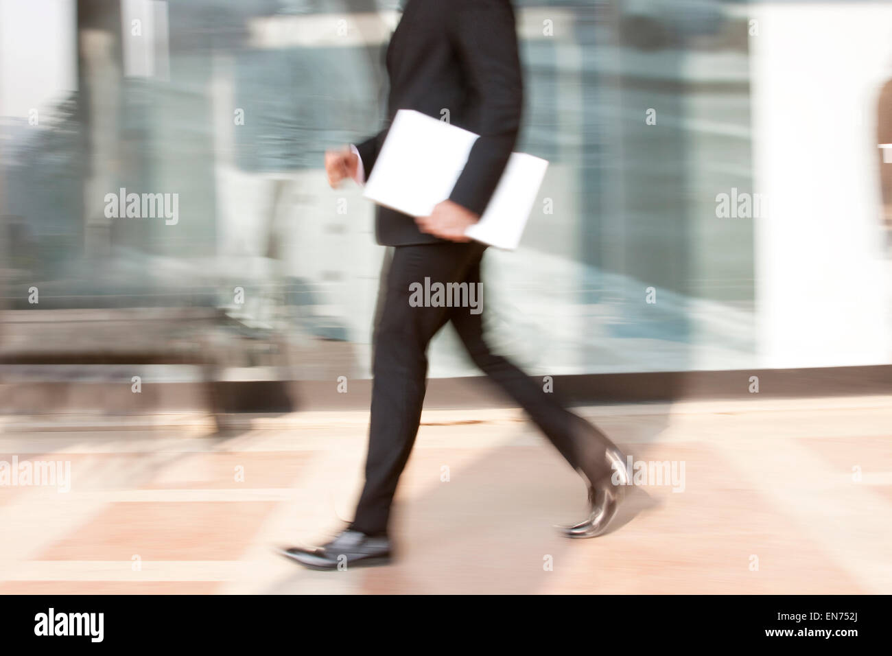 Businessman with a laptop walking hi-res stock photography and images ...
