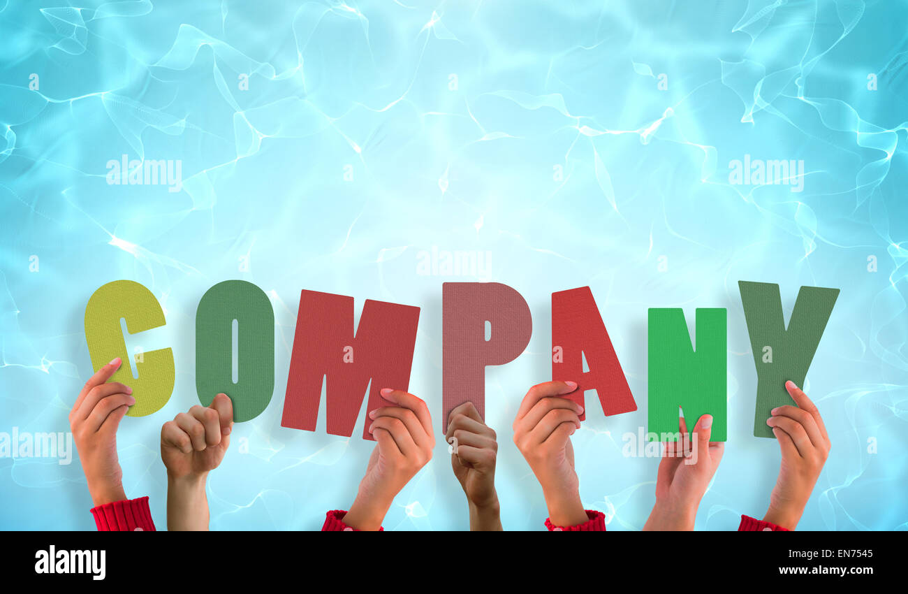 Composite image of hands holding up company Stock Photo - Alamy