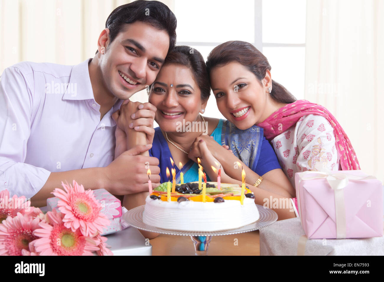 Portrait of family with a birthday cake Stock Photo - Alamy