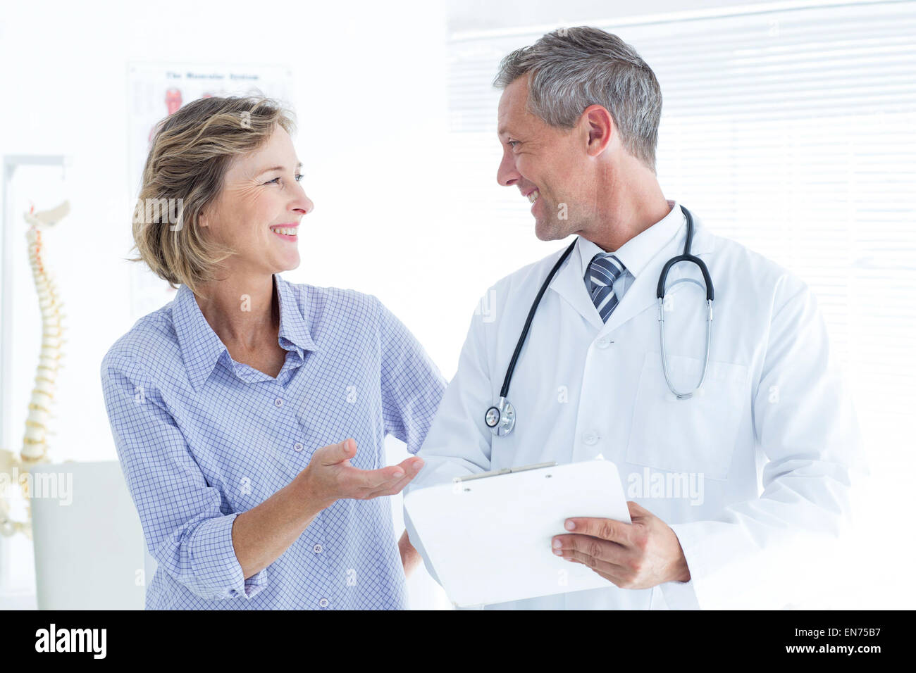 Doctor showing his notes to his patient Stock Photo - Alamy