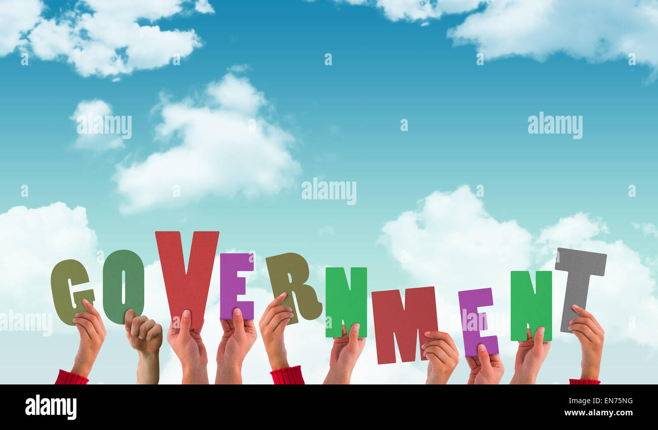 Composite image of hands holding up government Stock Photo - Alamy