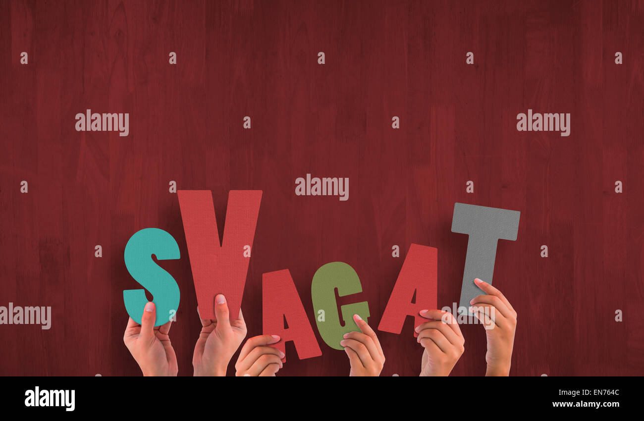 Composite image of hands holding up svagat Stock Photo - Alamy