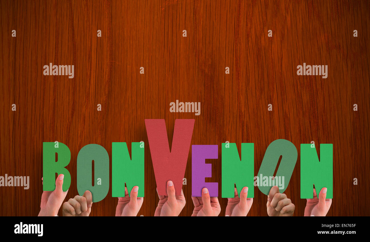 Composite image of hands holding up bonvenom Stock Photo - Alamy