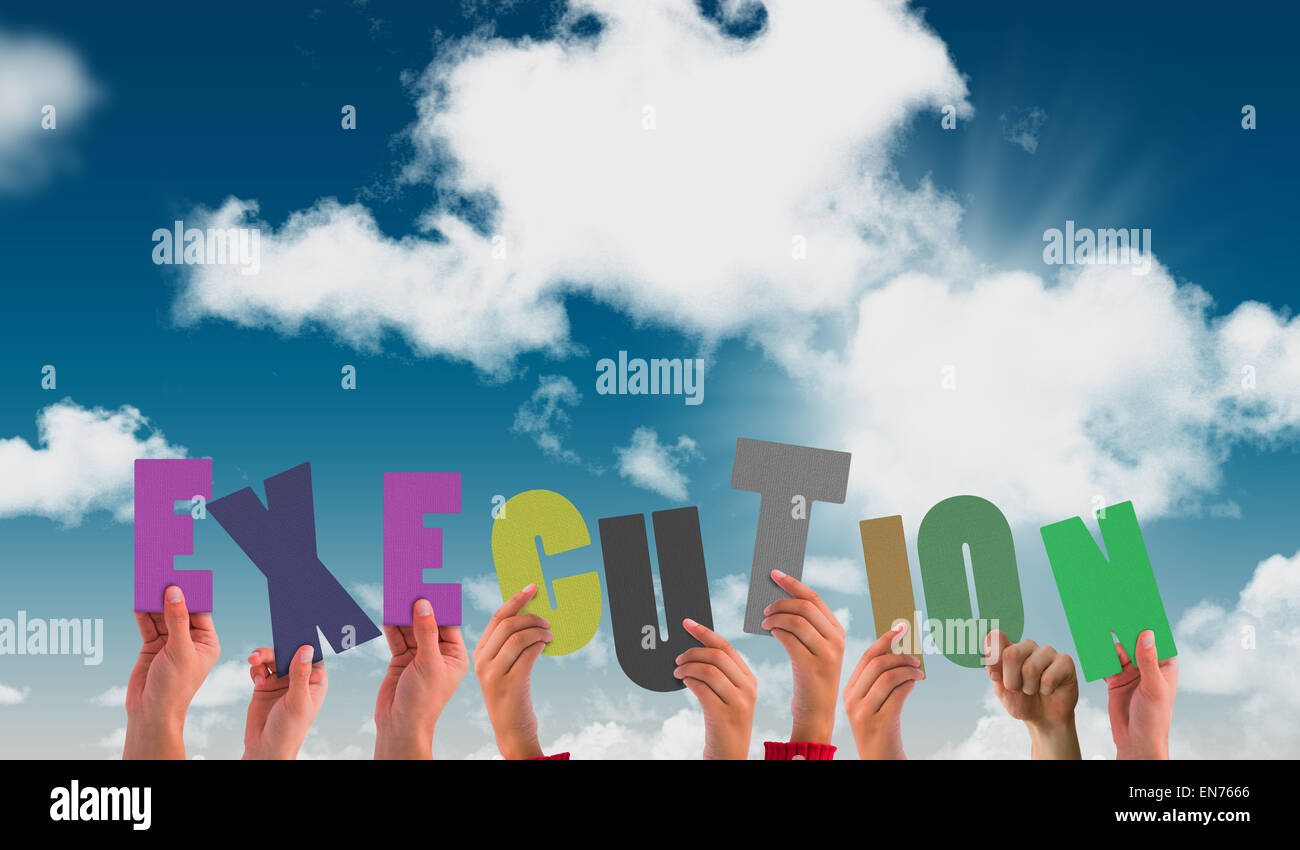 Composite image of hands holding up execution Stock Photo - Alamy