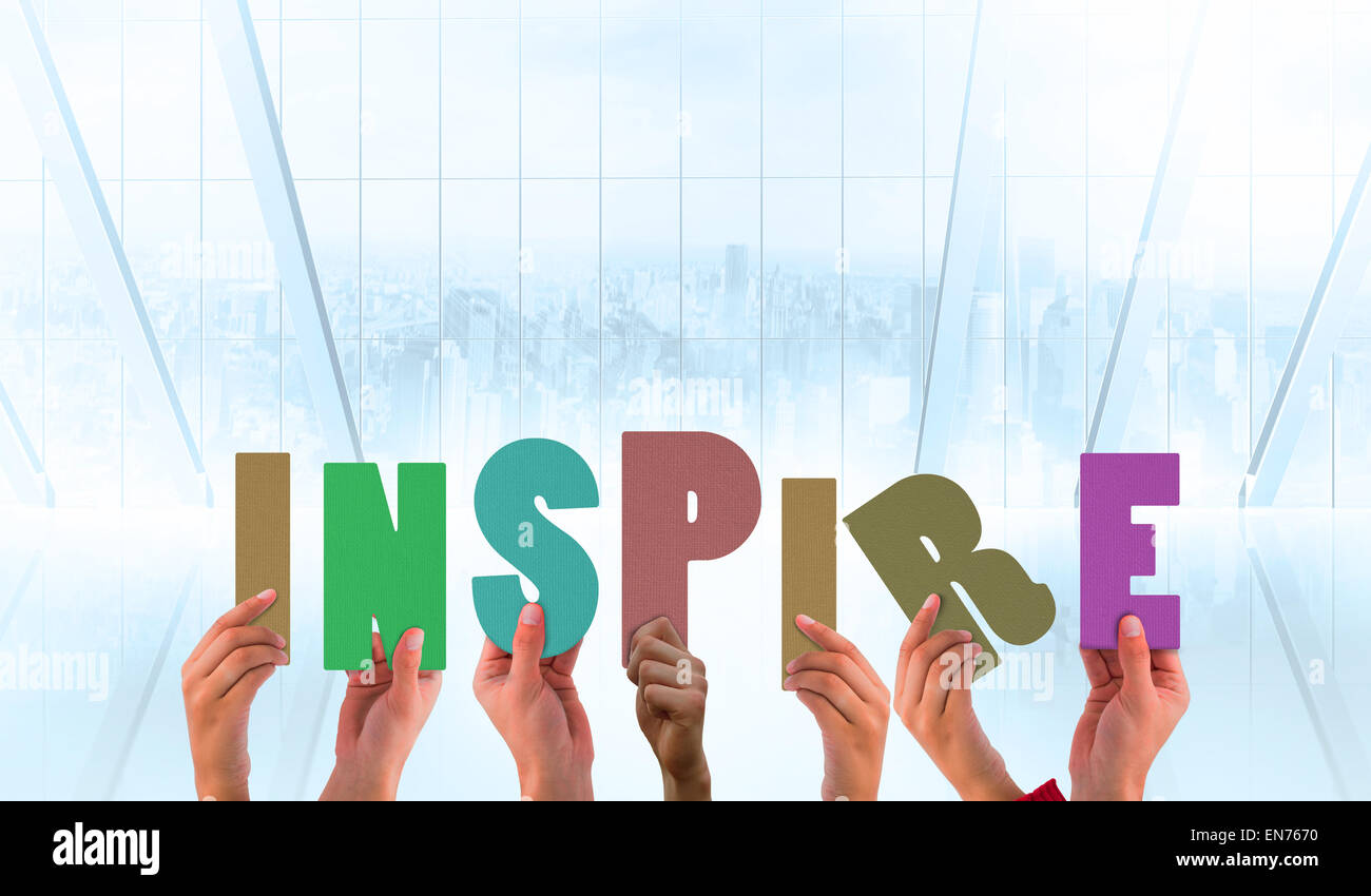 Composite image of hands holding up inspire Stock Photo - Alamy