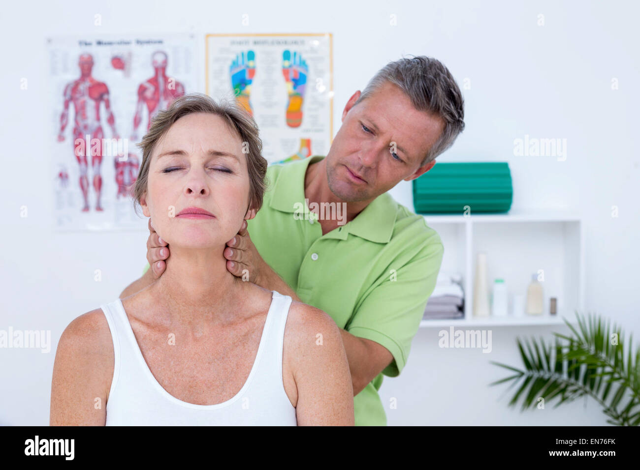 Doctor doing neck adjustment Stock Photo - Alamy