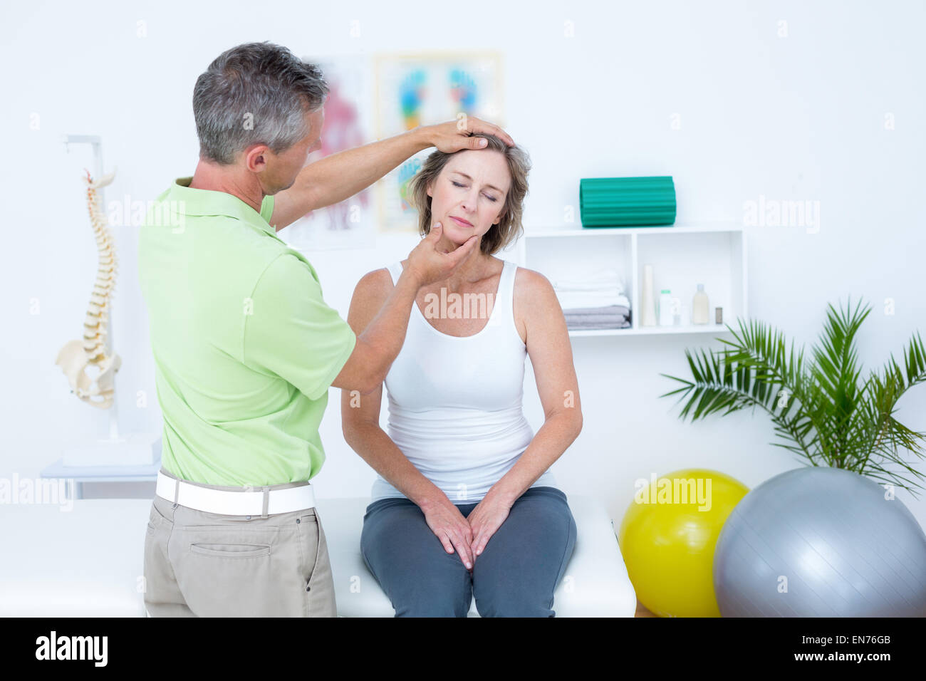 Doctor doing neck adjustment Stock Photo - Alamy