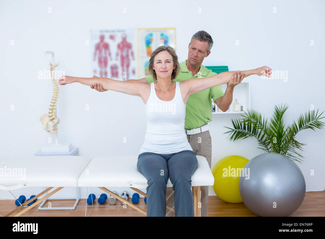 Doctor stretching his patients arms Stock Photo - Alamy