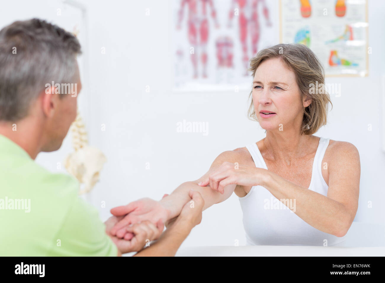 Doctor examining his patients arm Stock Photo - Alamy
