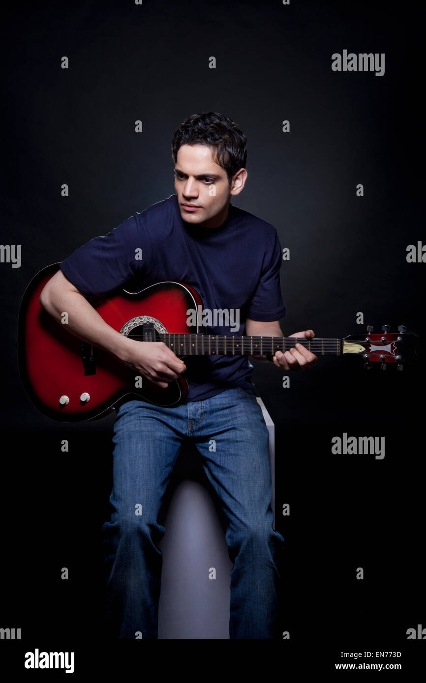Young man playing the guitar Stock Photo - Alamy