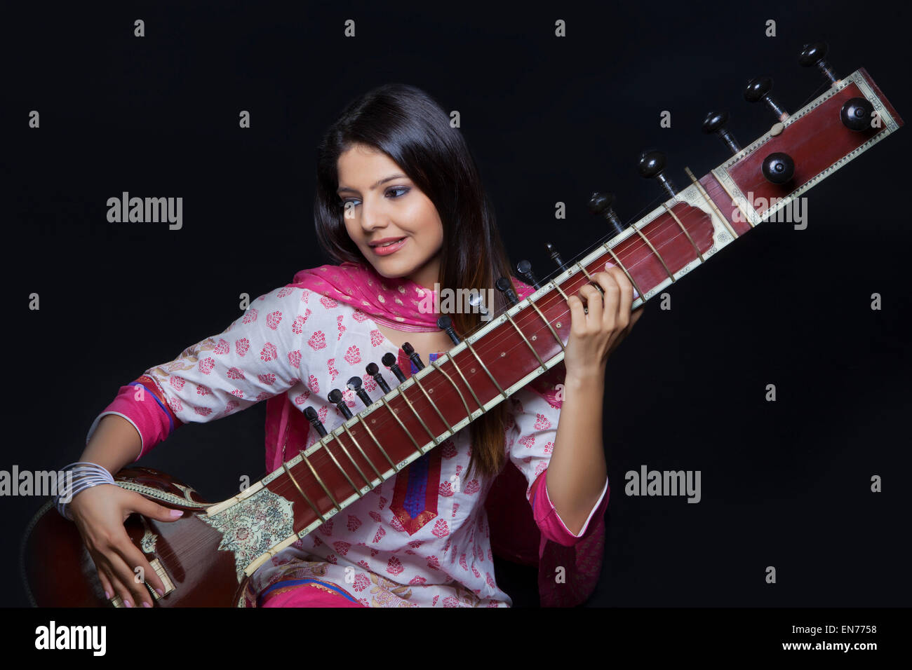 Young woman playing sitar hi-res stock photography and images - Alamy