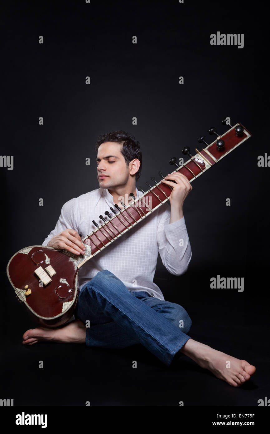 Young man playing the sitar Stock Photo - Alamy