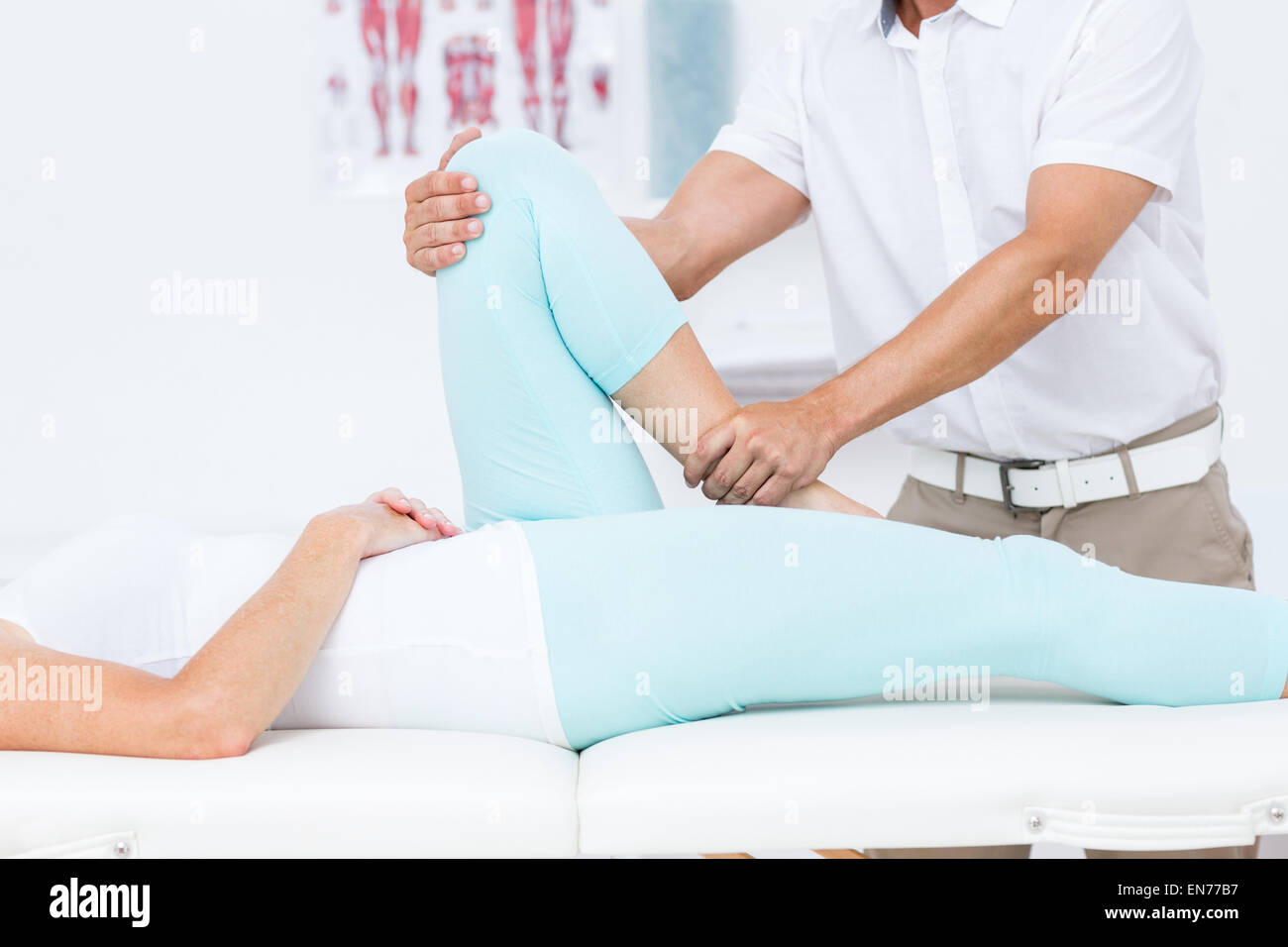 Doctor stretching his patients leg Stock Photo - Alamy
