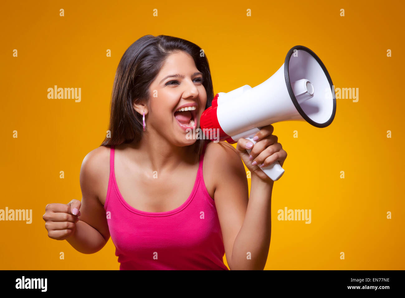 Young woman screaming into a megaphone Stock Photo - Alamy