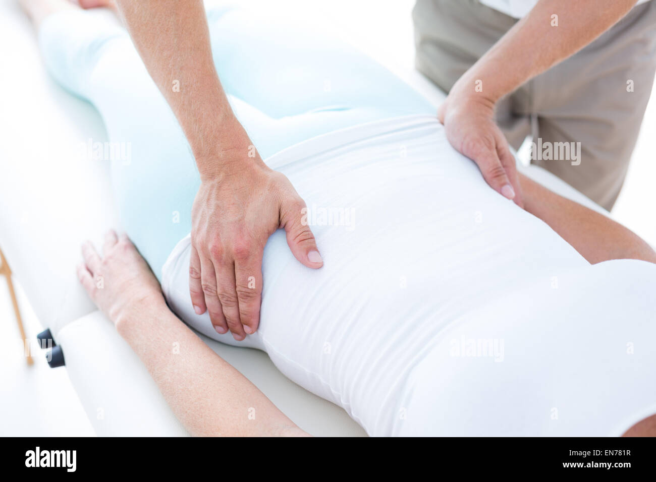 Doctor touching stomach mature patient hi-res stock photography and ...