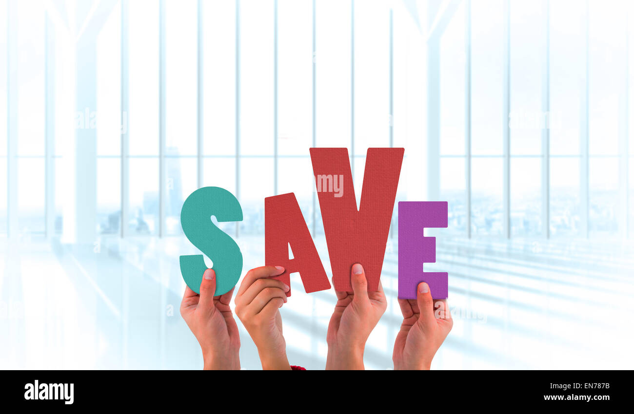Composite image of hands holding up save Stock Photo - Alamy