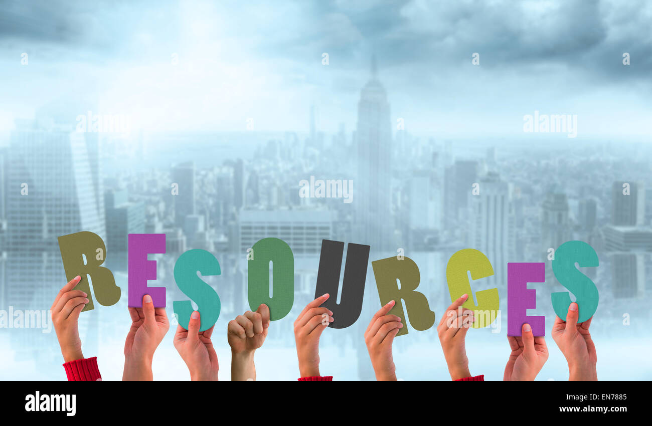 Composite image of hands showing resources Stock Photo - Alamy