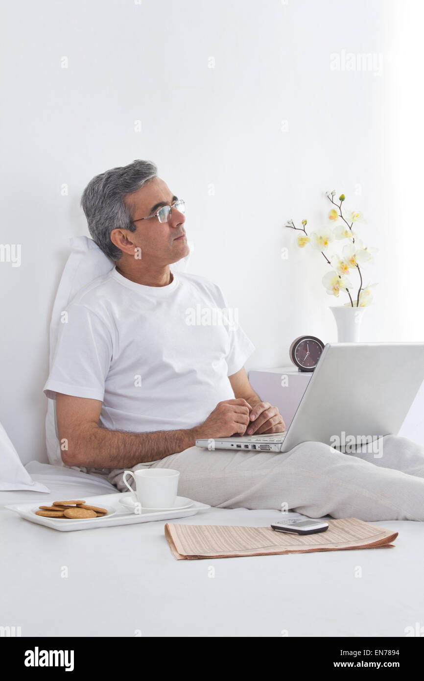Man working on his laptop Stock Photo - Alamy