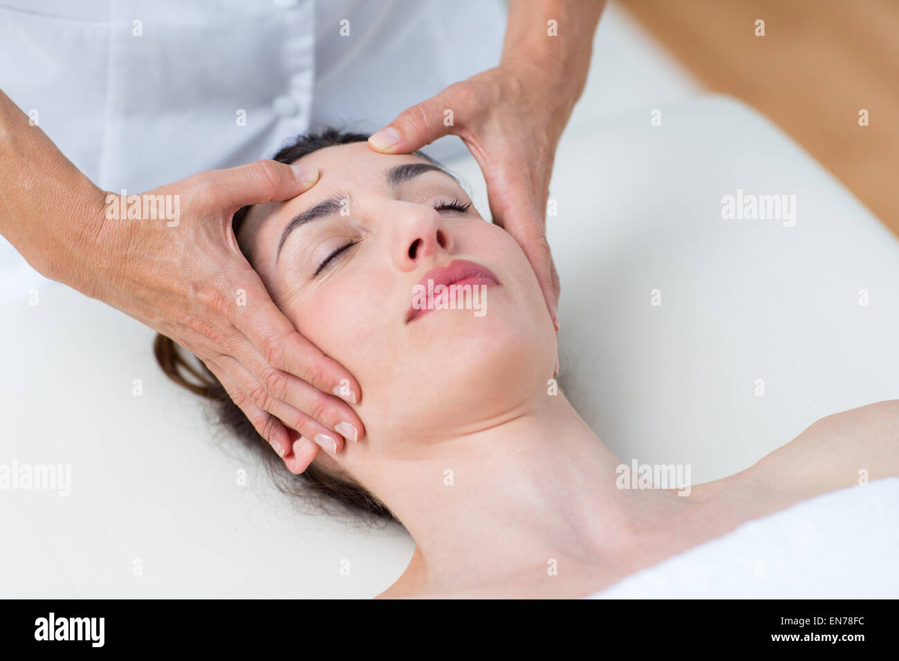 Physiotherapist doing head massage Stock Photo - Alamy