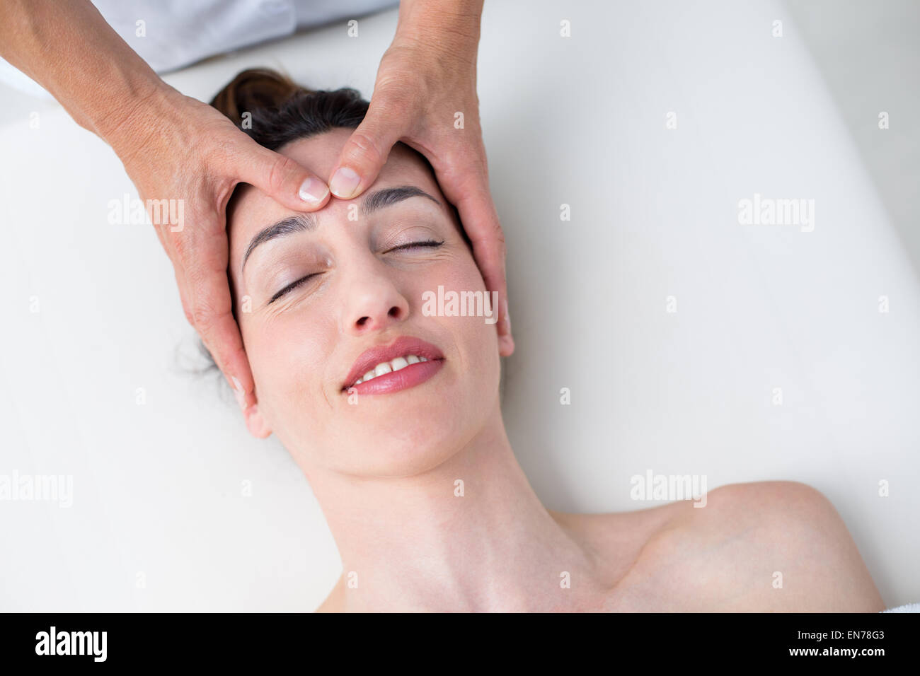 Physiotherapist doing head massage Stock Photo - Alamy