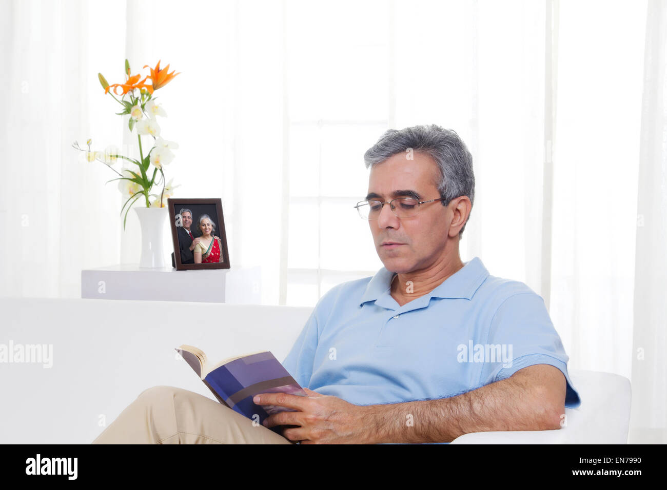 Adult man reading a book Stock Photo - Alamy
