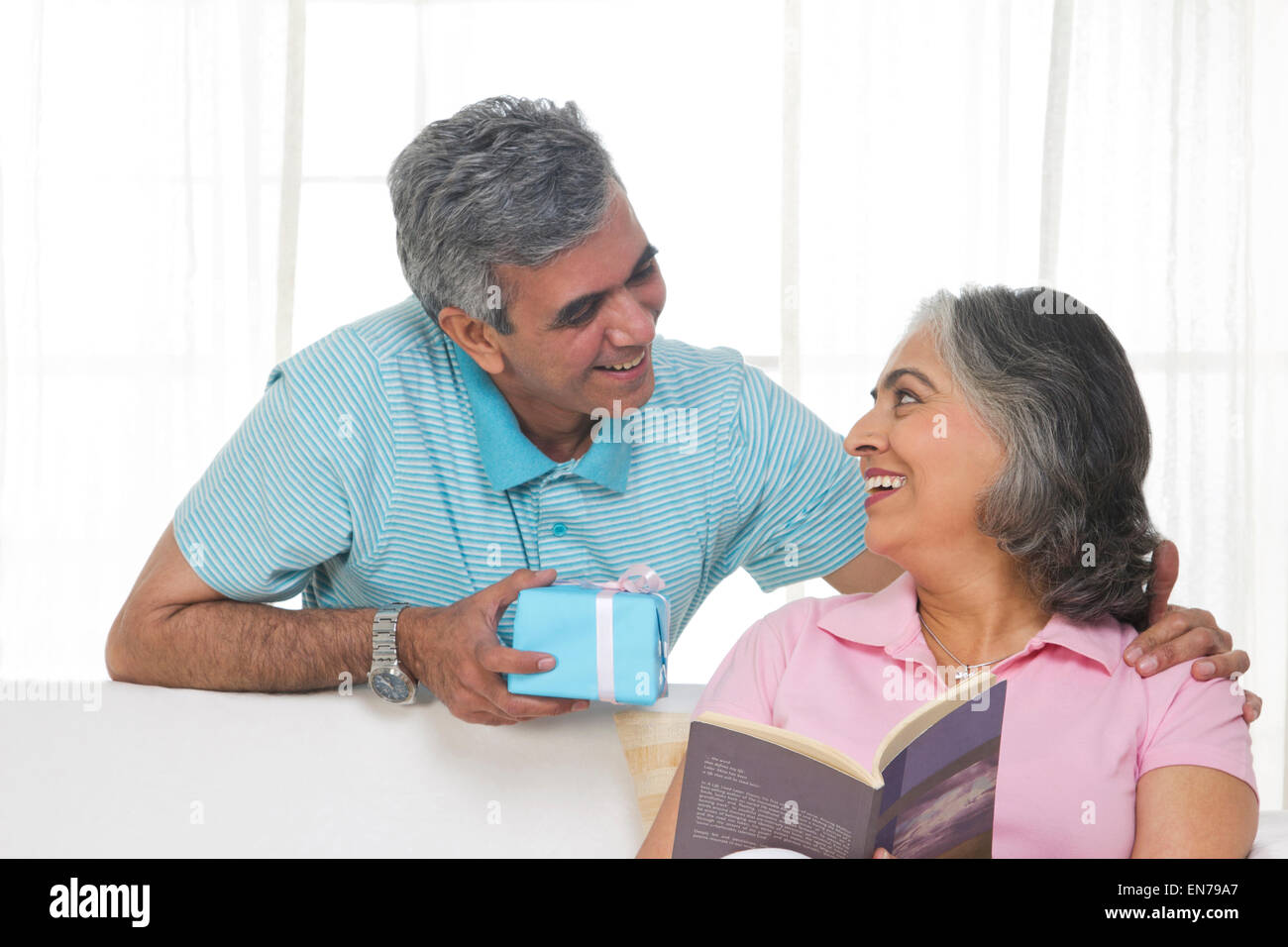 Husband giving a gift to his wife Stock Photo - Alamy