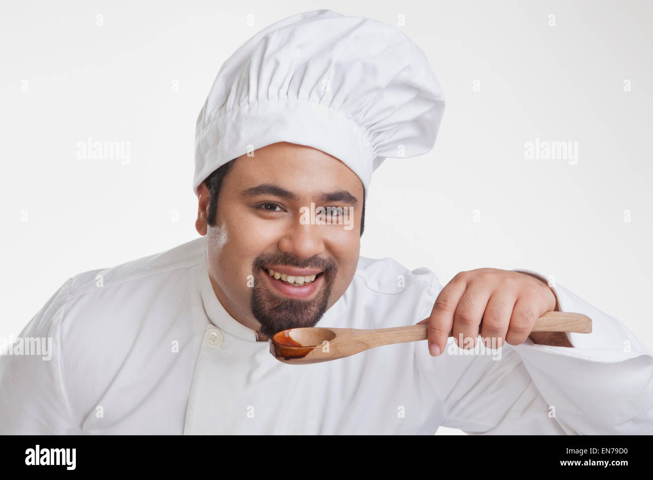 Portrait of chef with wooden spoon smiling Stock Photo - Alamy