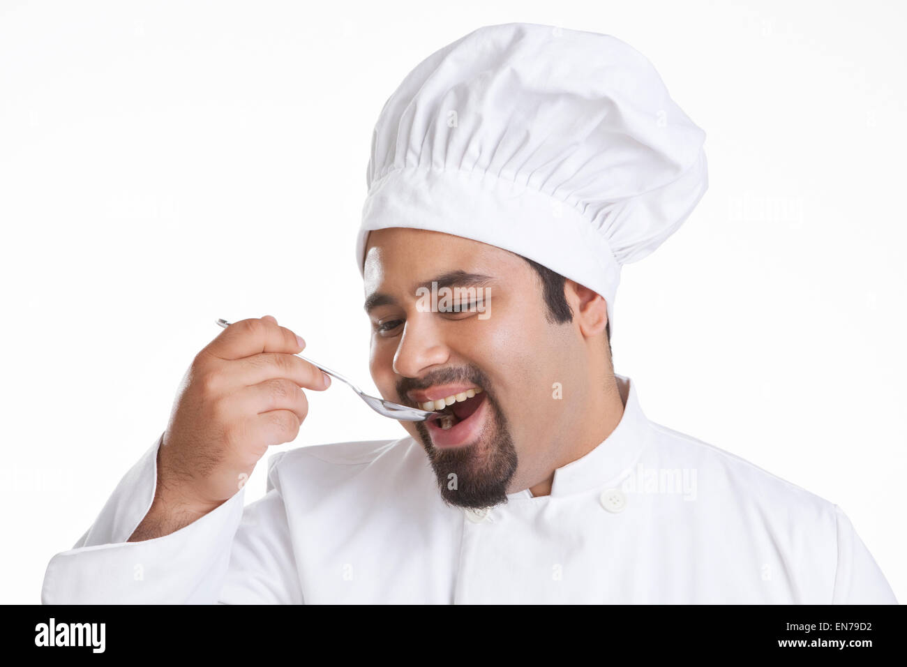 Chef eating from spoon Stock Photo - Alamy