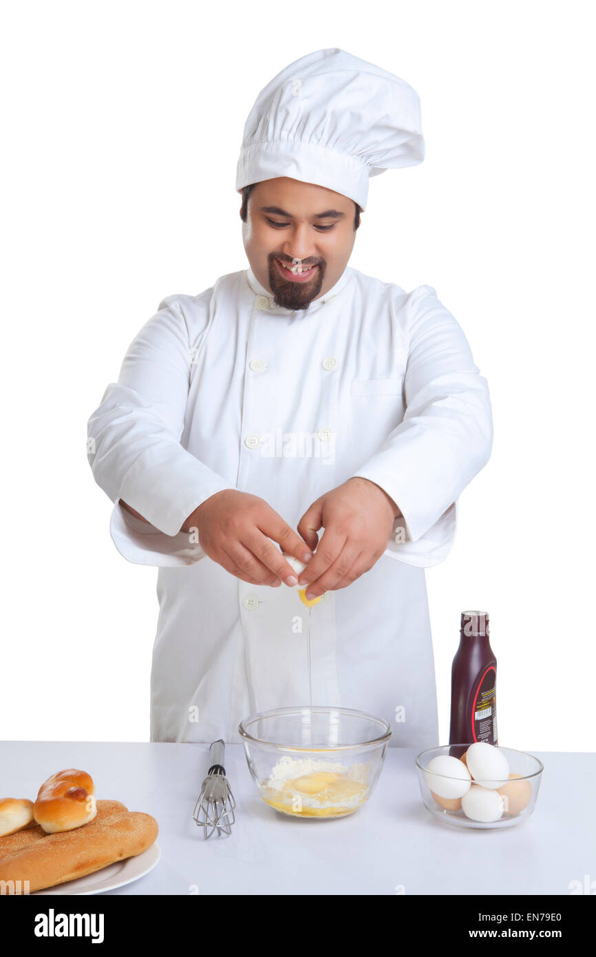 Chef cracking egg into bowl Stock Photo - Alamy