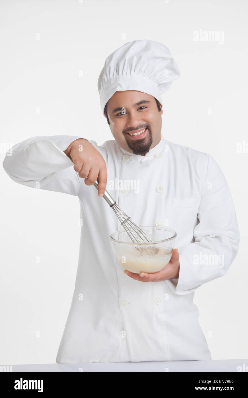 Portrait of chef mixing egg in bowl Stock Photo - Alamy