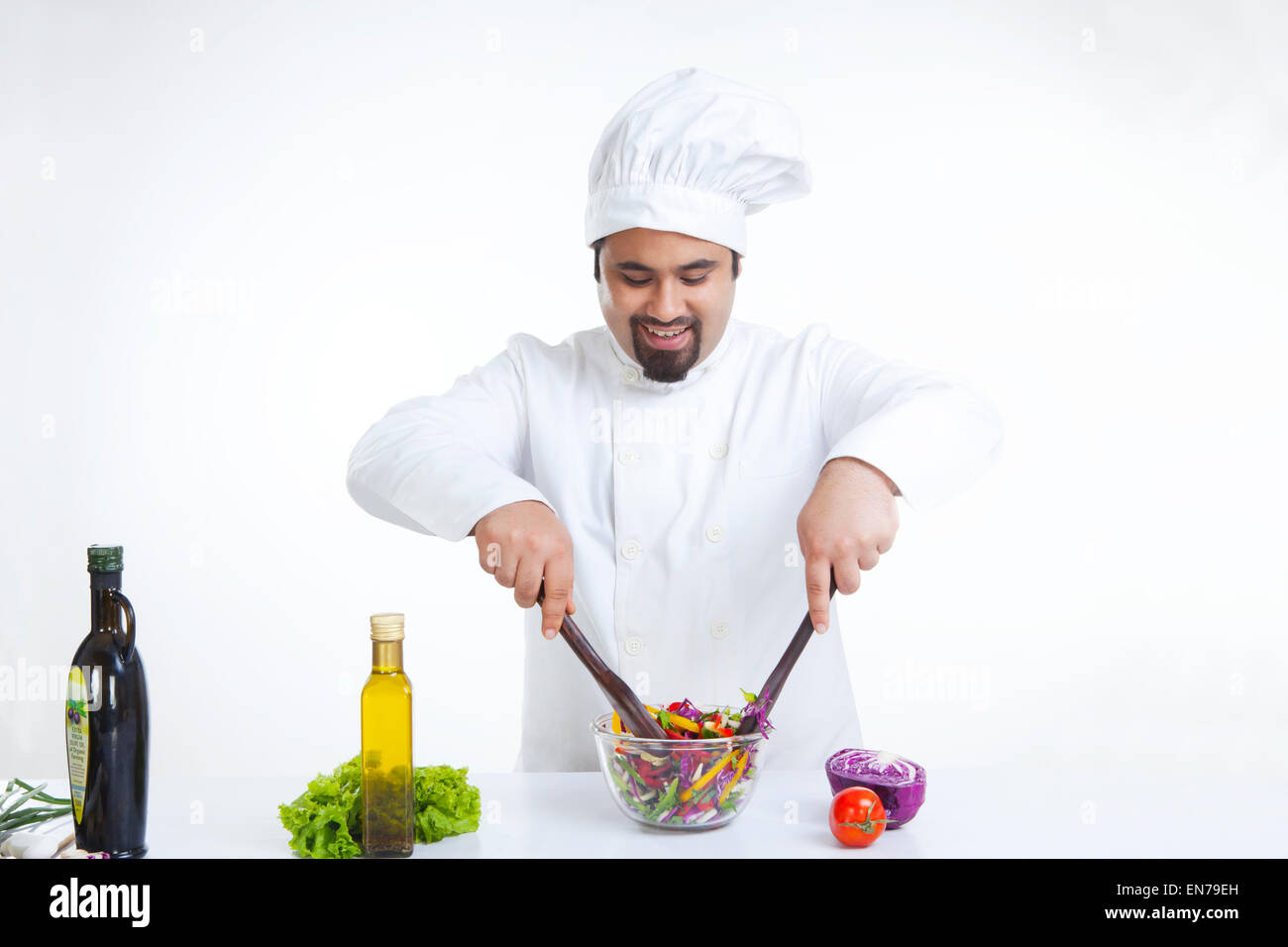 Chef mixing vegetables in bowl Stock Photo - Alamy