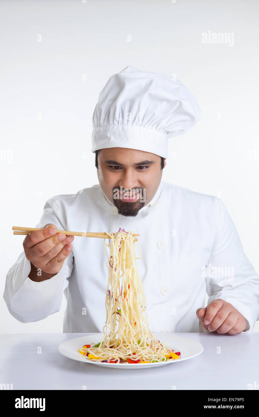 Chef lifting pasta with chopsticks Stock Photo - Alamy