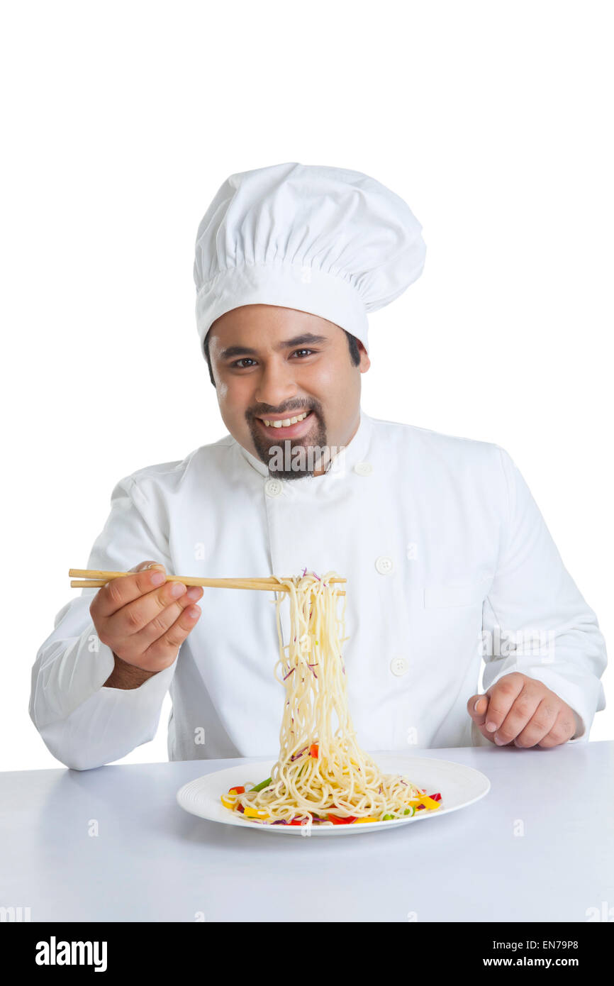 Portrait of chef lifting pasta with chopsticks Stock Photo - Alamy
