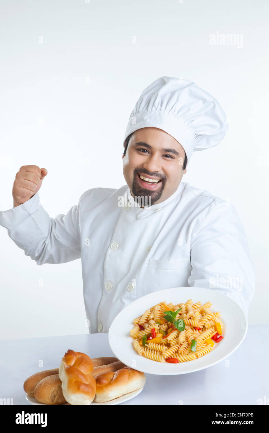 Portrait of chef with plate of pasta Stock Photo - Alamy