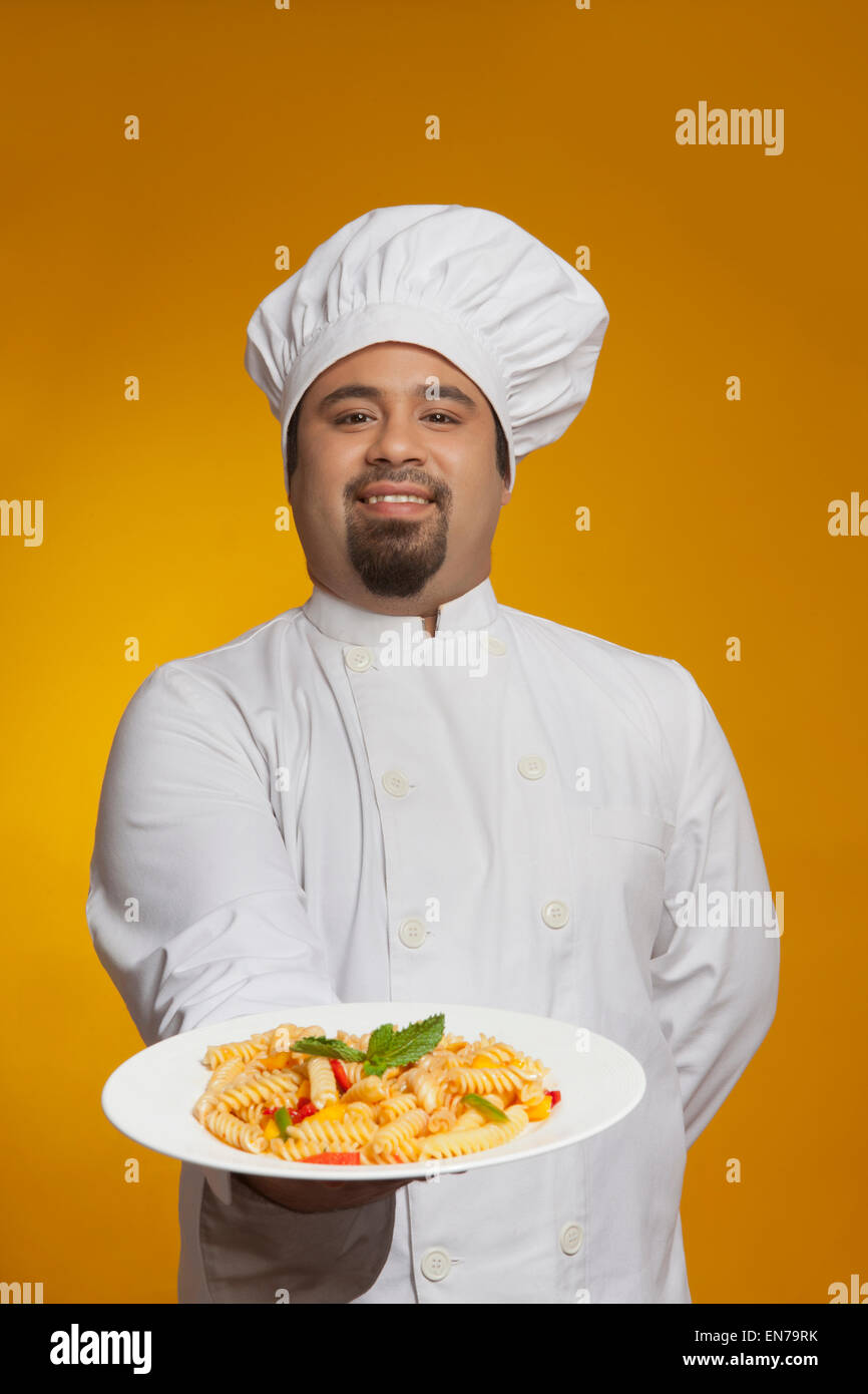 Portrait of chef with plate of pasta Stock Photo - Alamy
