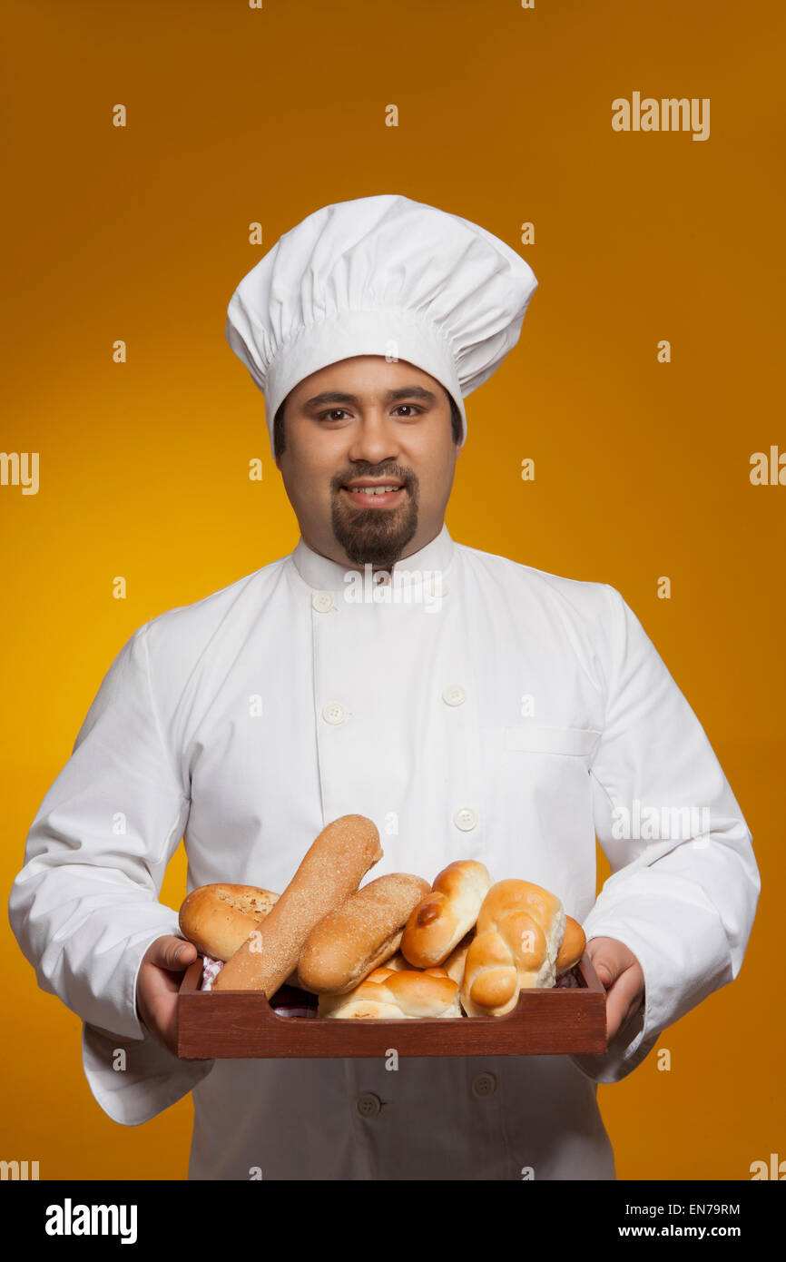 Portrait of chef with tray of bread Stock Photo - Alamy